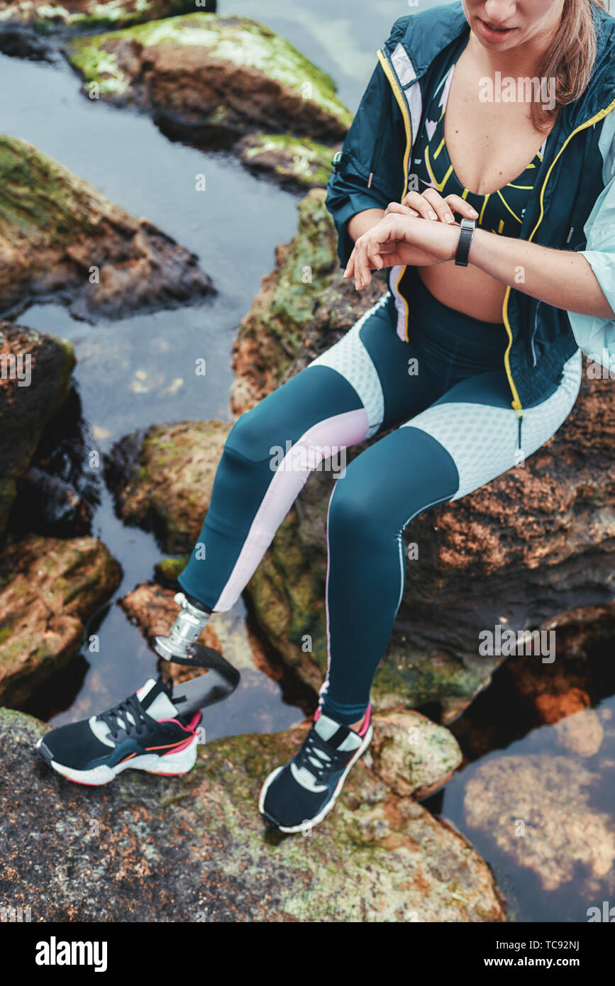 Checking results. Cropped photo of disabled athlete woman in sportswear ...