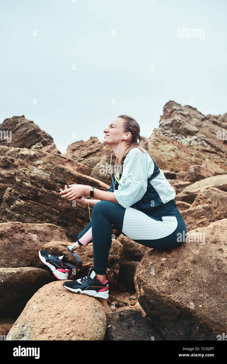 It was great workout. Happy disabled woman in sport wear with leg ...