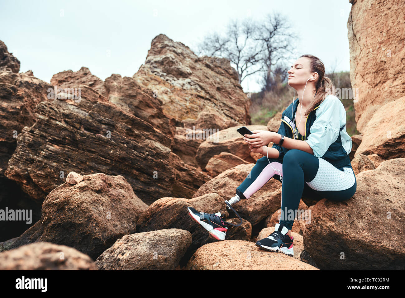 Feeling free. Happy disabled women in sport wear with leg prosthesis ...