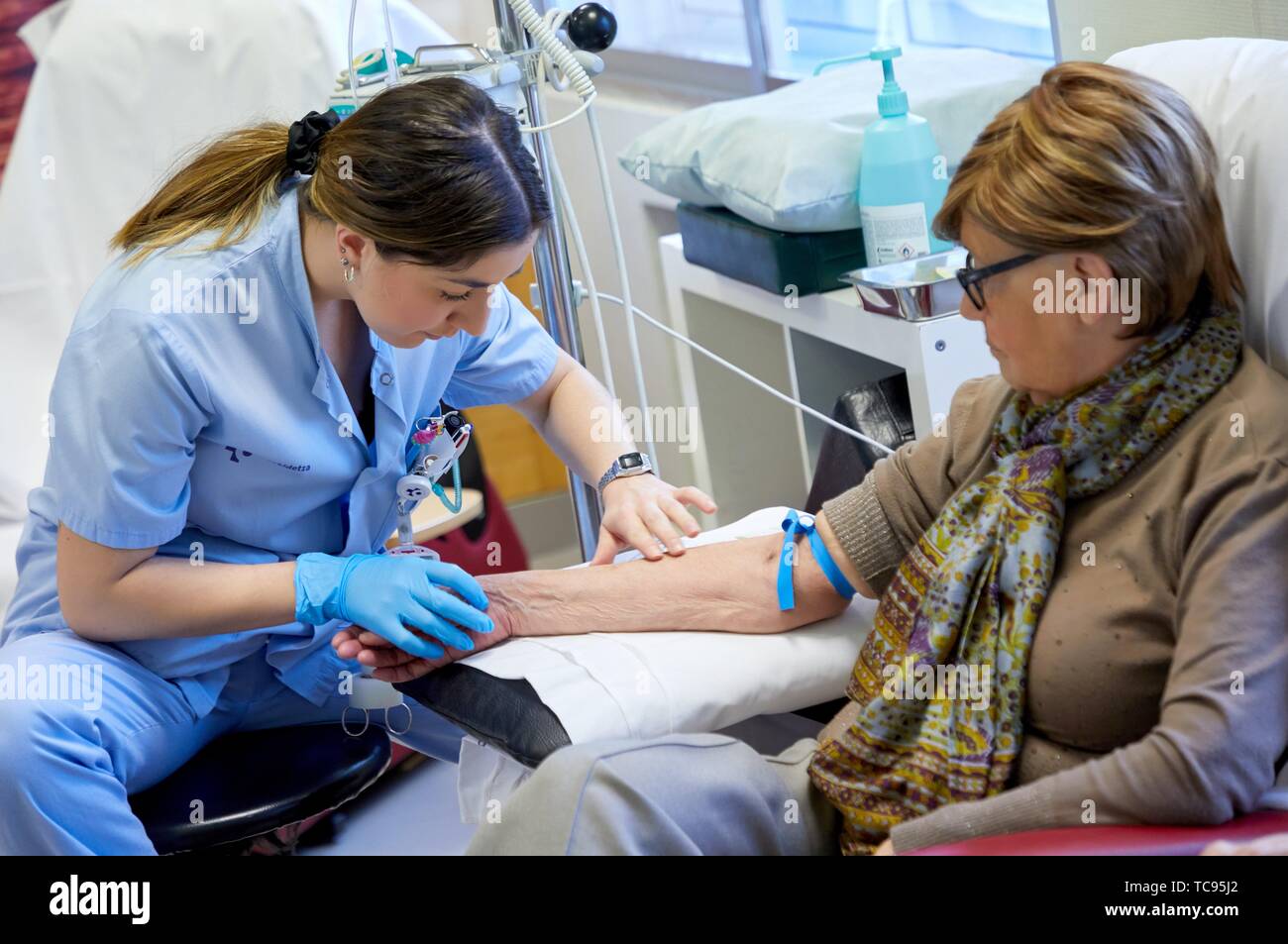 Nurse putting medication intravenously to a patient, Chemotherapy ...