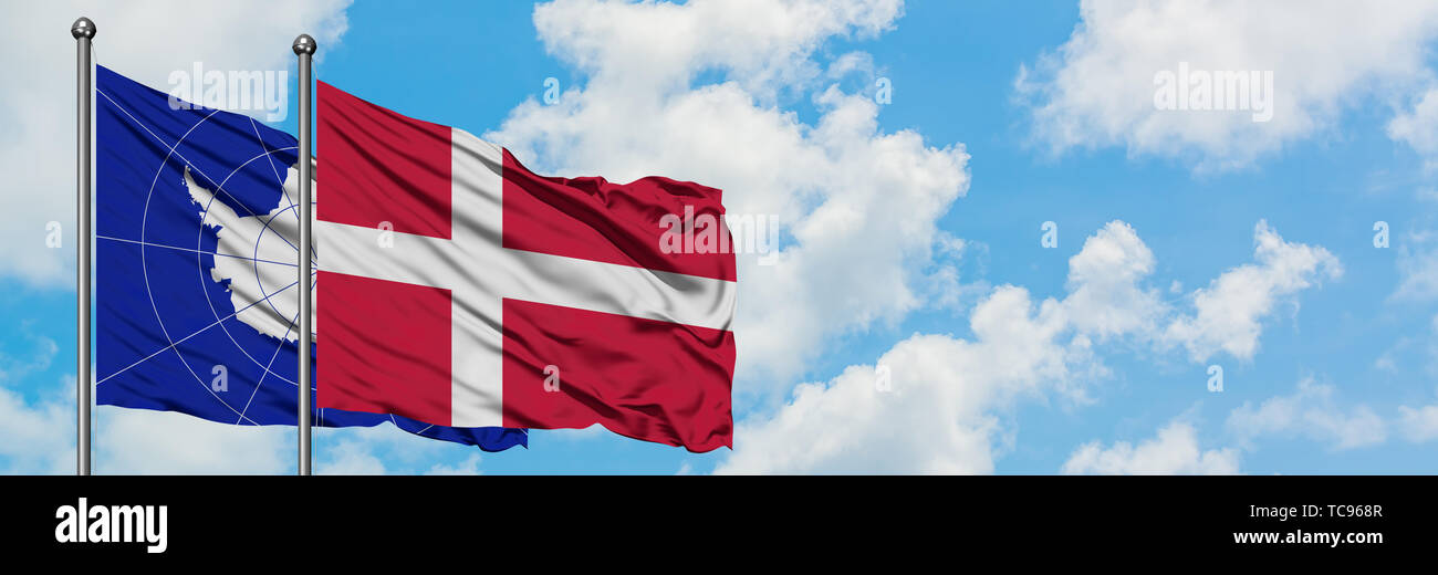 Antarctica and Denmark flag waving in the wind against white cloudy ...