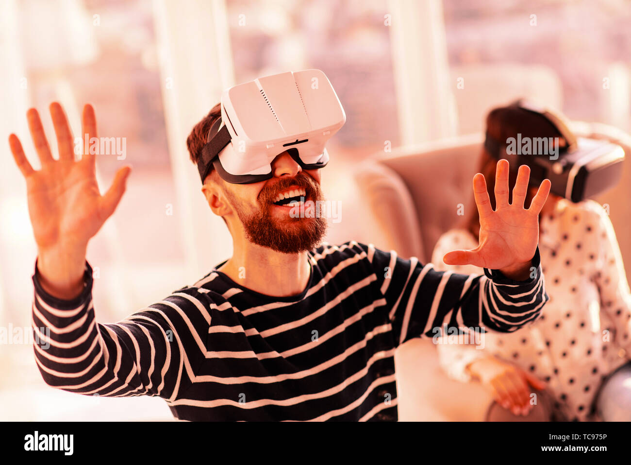 High-spirited man and woman expericing a new game together Stock Photo ...