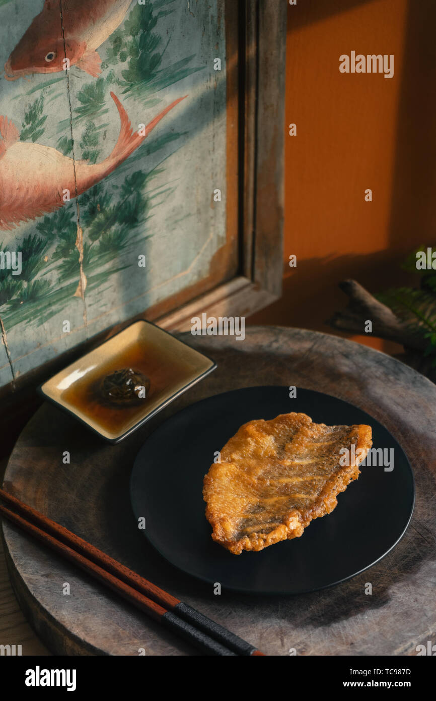 A fried fish chop on the chopping board Stock Photo - Alamy