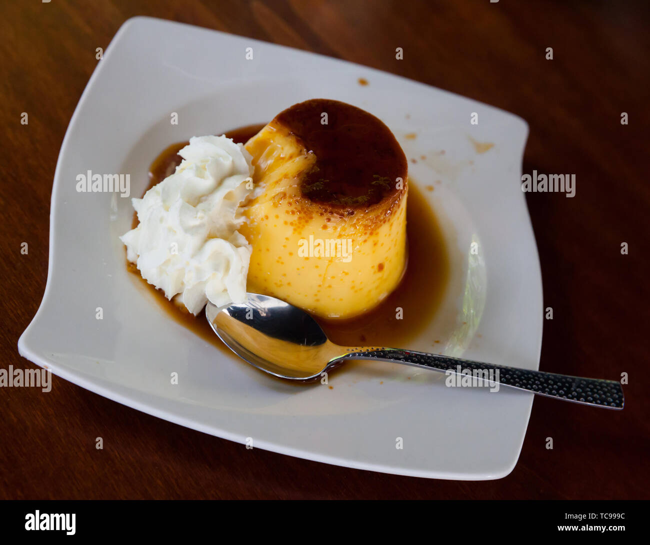 Tasty sweet custard flan with air whipped cream and caramel topping ...