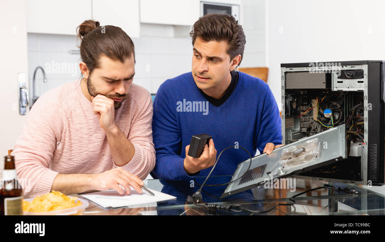Men drink beer and repair the desktop computer Stock Photo - Alamy