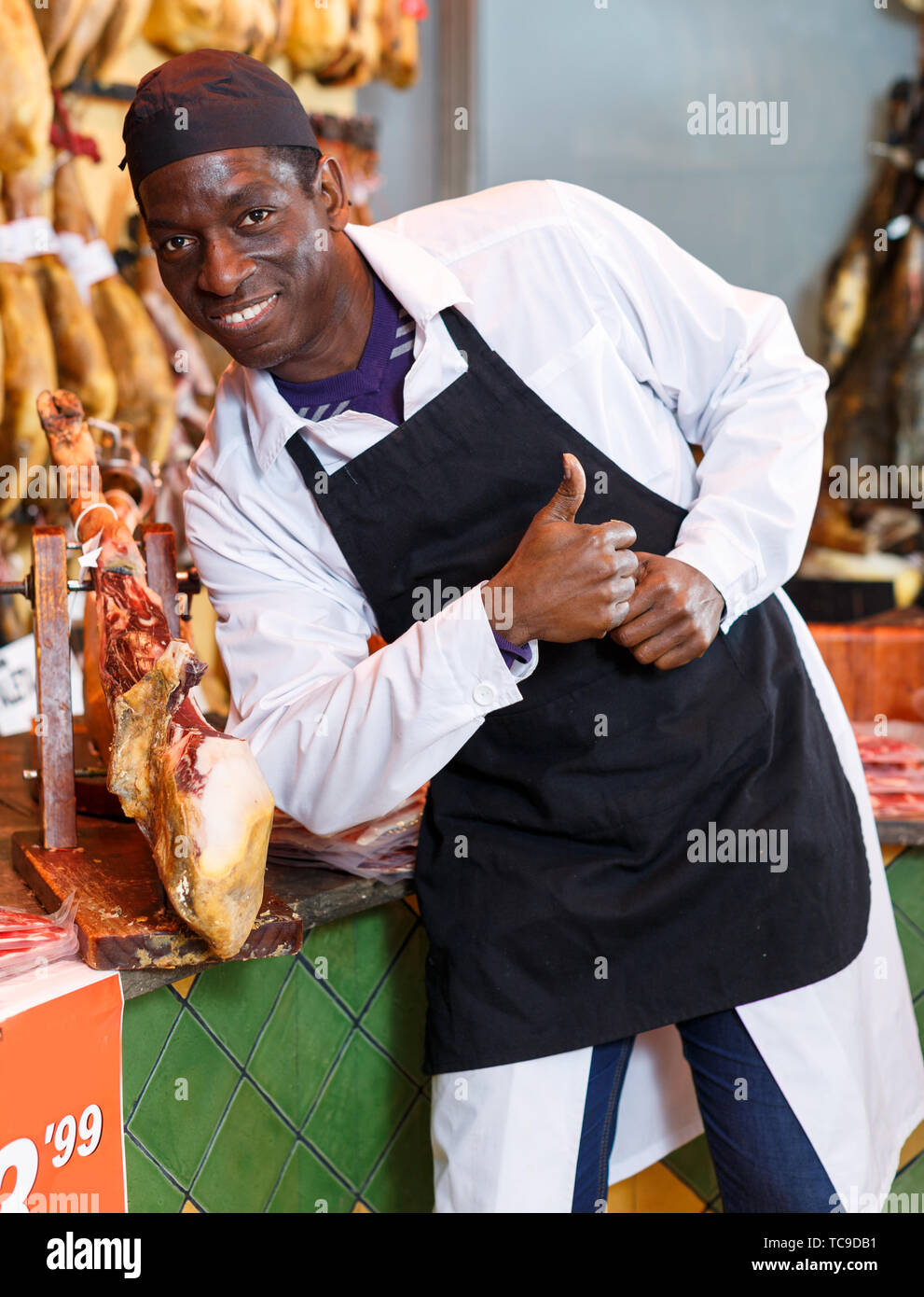 Successful butcher shop owner giving thumbs up, satisfied with quality ...