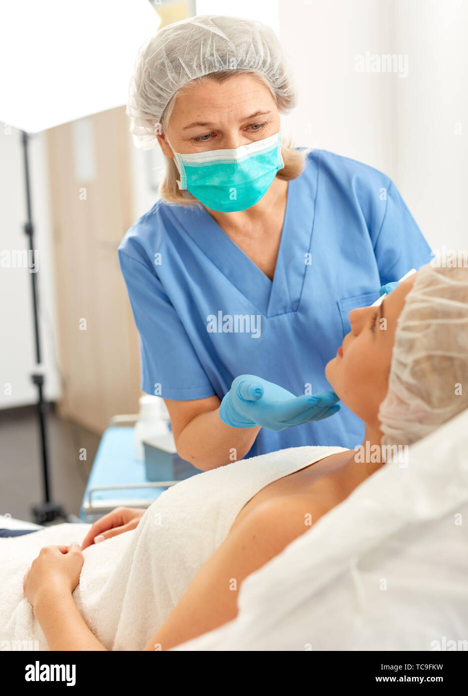 Plastic surgeon preparing for operation on woman face Stock Photo - Alamy