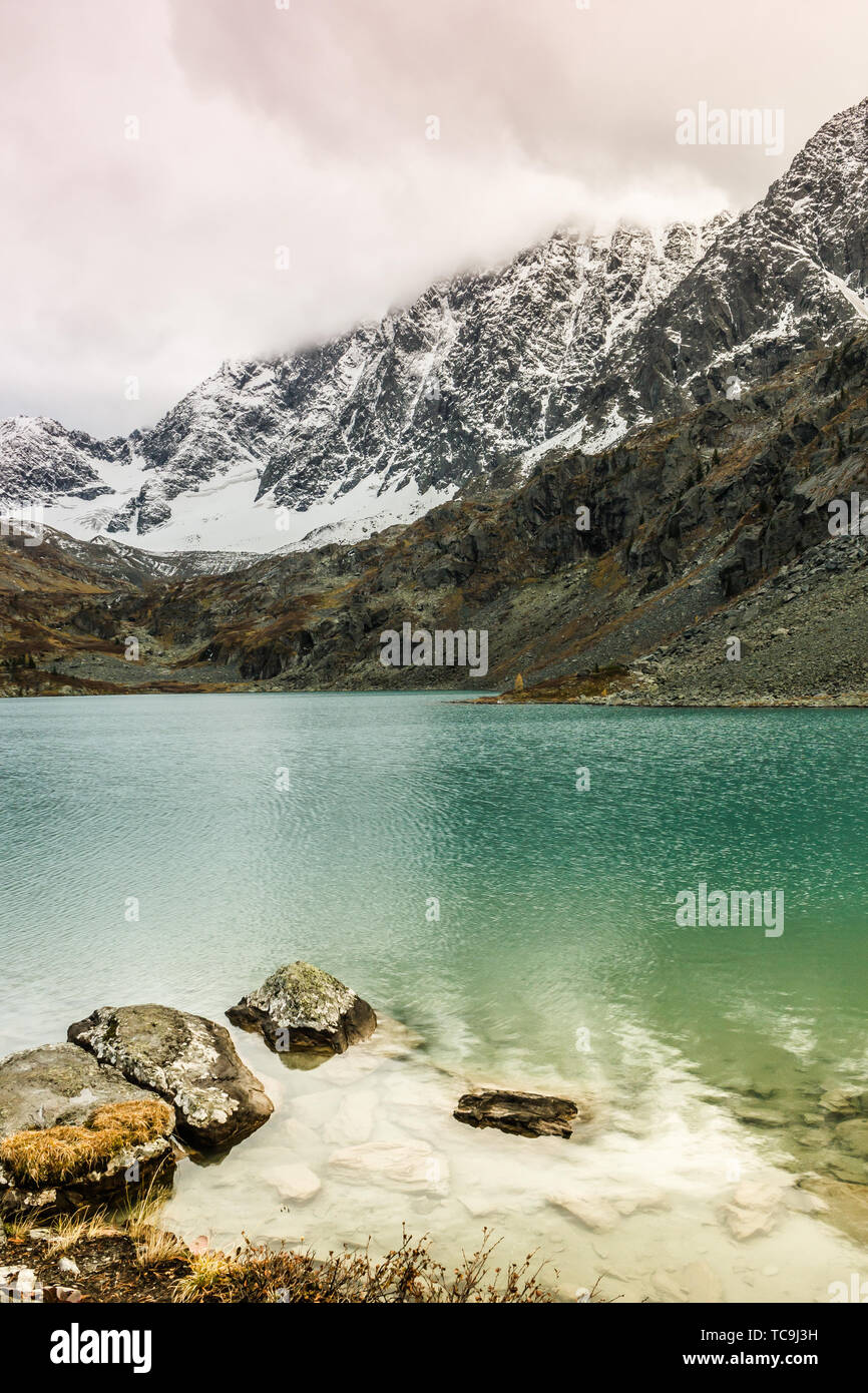 Mountain lake, rocks are reflected in water surface Stock Photo - Alamy