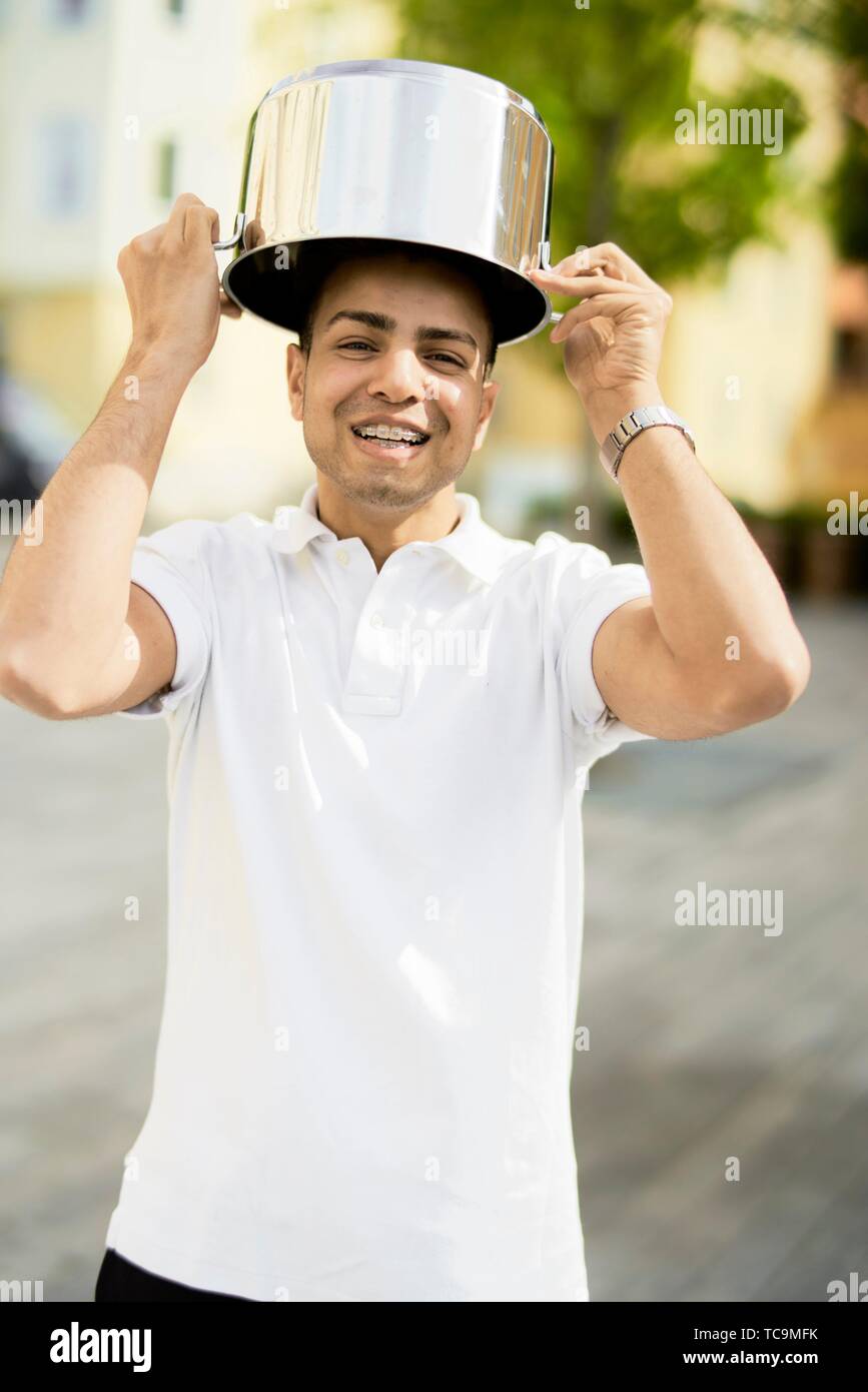 sanguine Afghan man with cooking pot on head, in Munich, Germany Stock ...