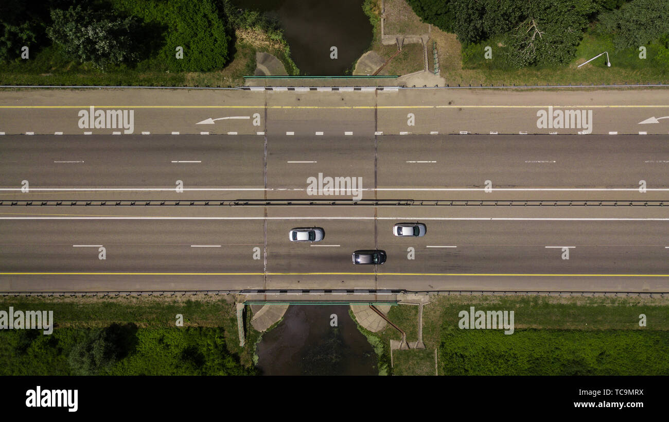 Top down close up of highway traffic, white arrow signs indicating ...