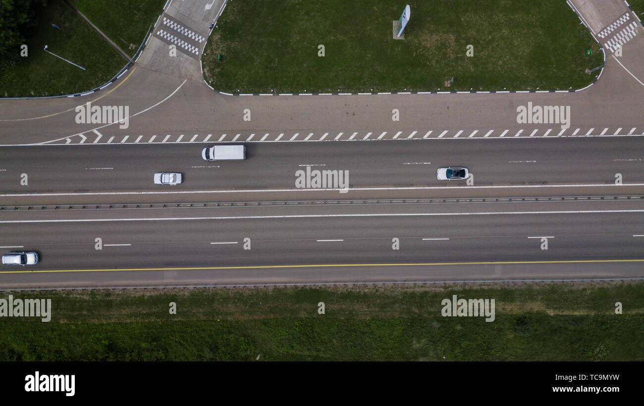 Top down close up of highway, white arrow signs indicating direction ...