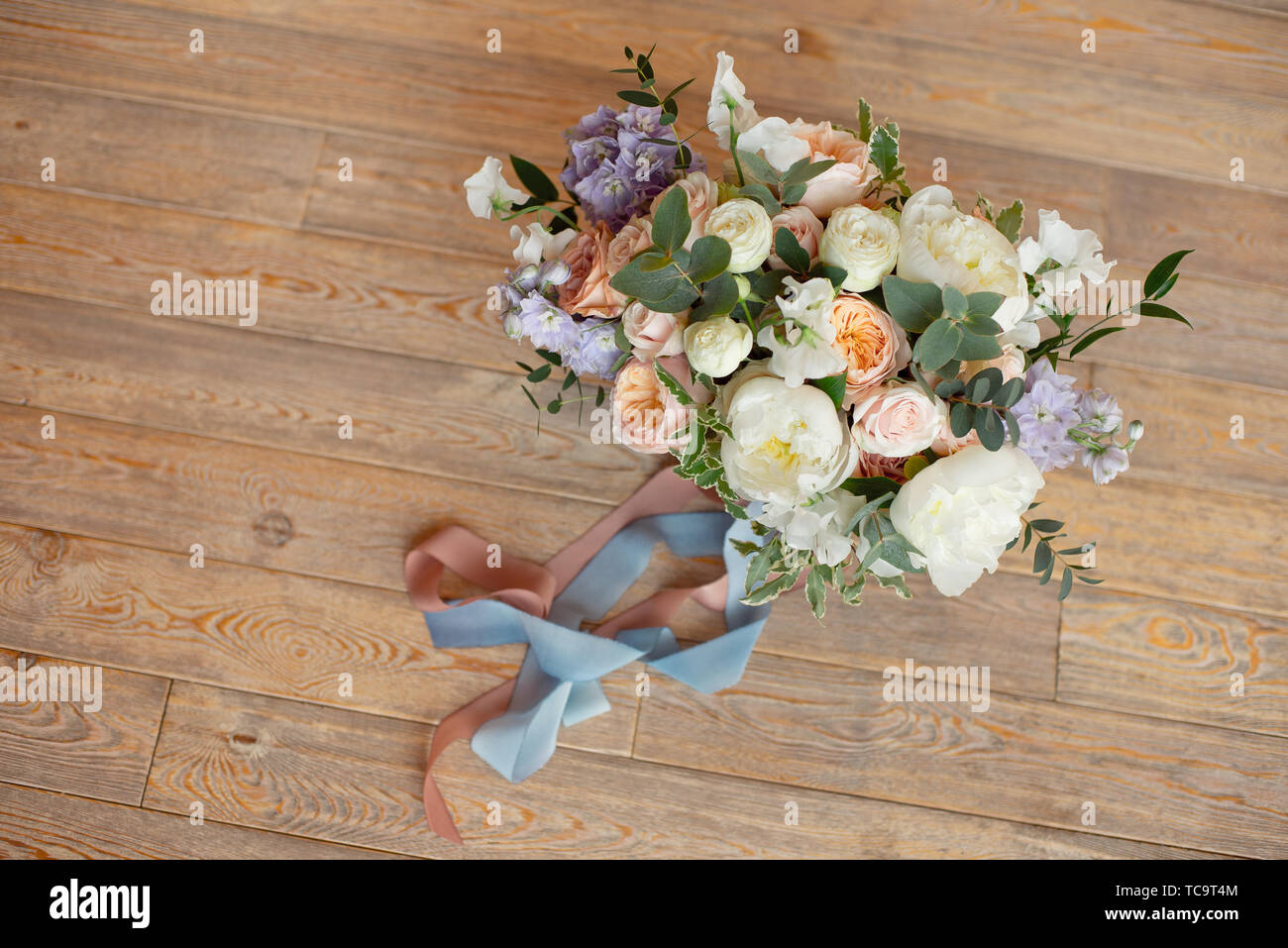 Close-up bouquet of roses peonies freesia dianthus flowers on the round ...