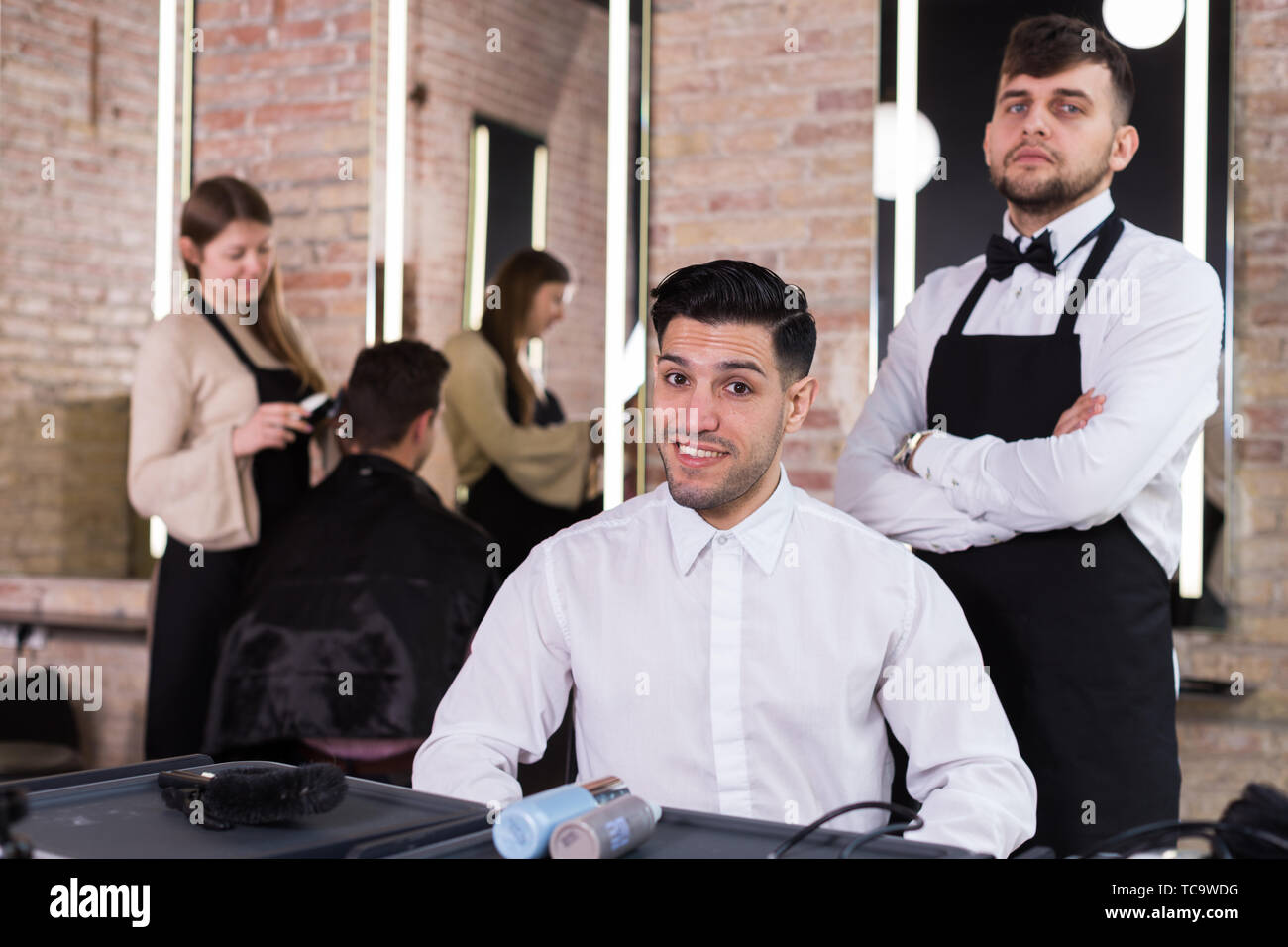 Portrait of delighted male client in salon after haircut from ...