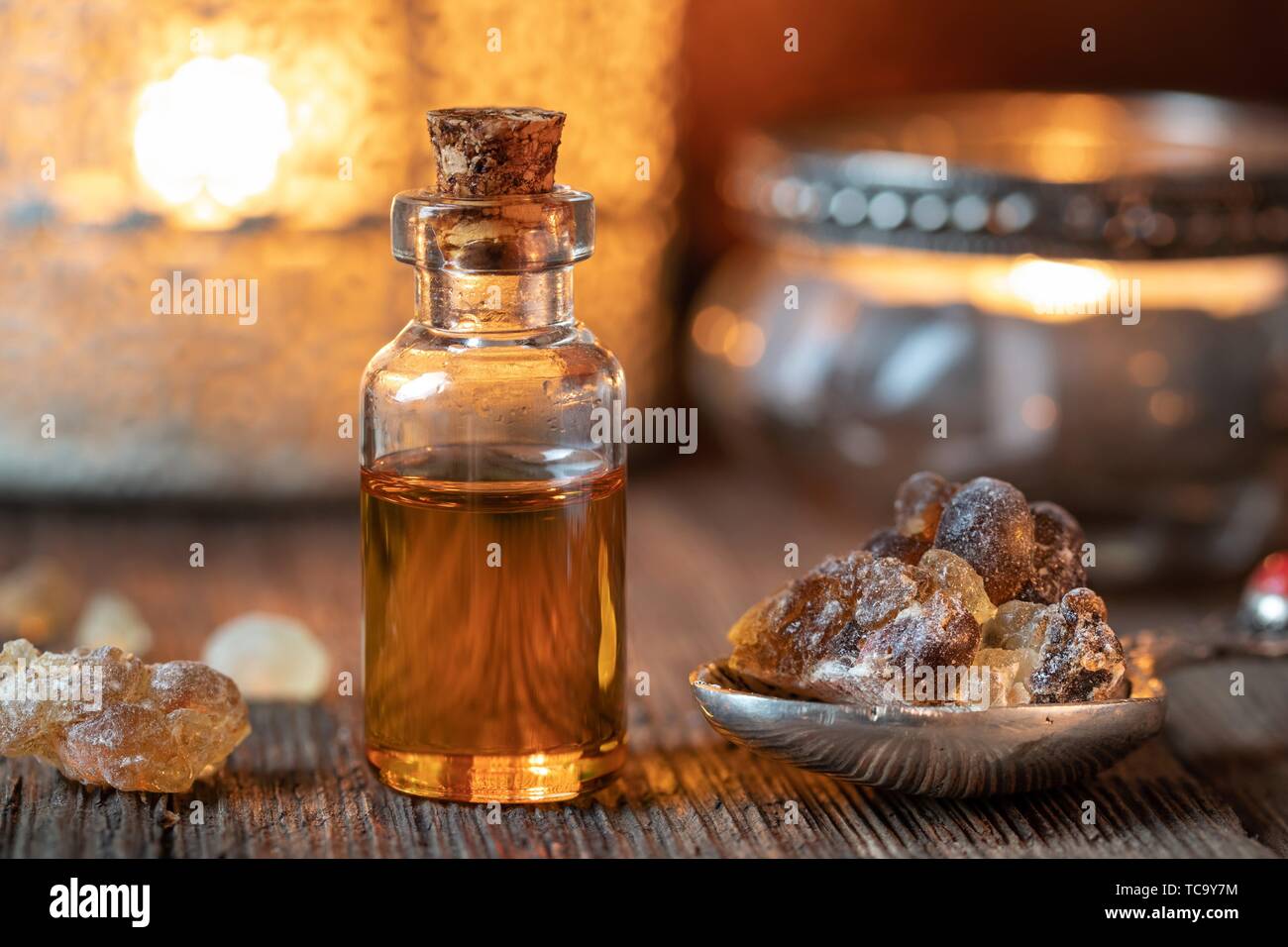 A bottle of essential oil with frankincense resin crystals Stock Photo ...