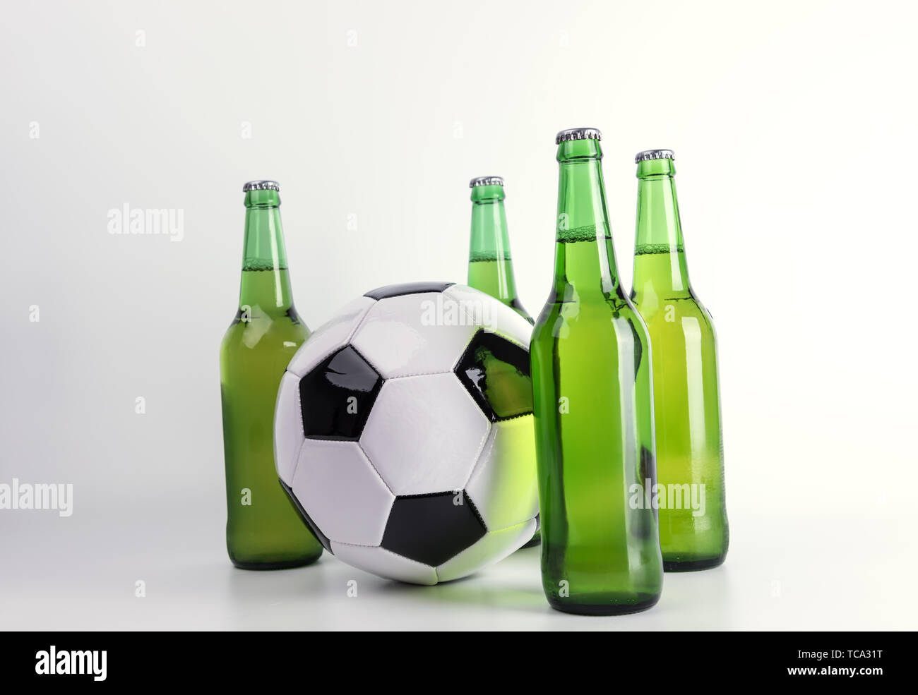 Fresh beer and football on white background Stock Photo - Alamy