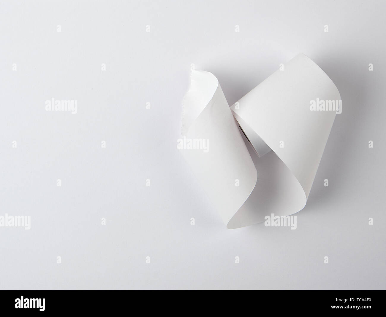 white piece of paper is twisted, white background, copy space Stock ...