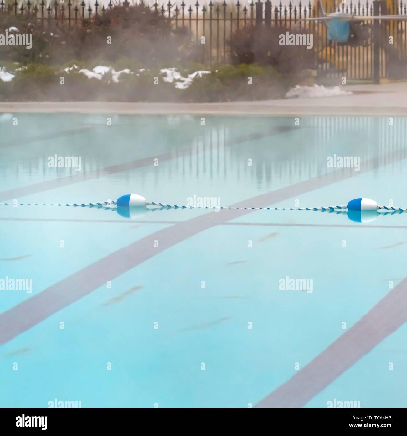 Square Blue and white buoy and rope lane marker floating on an outdoor ...