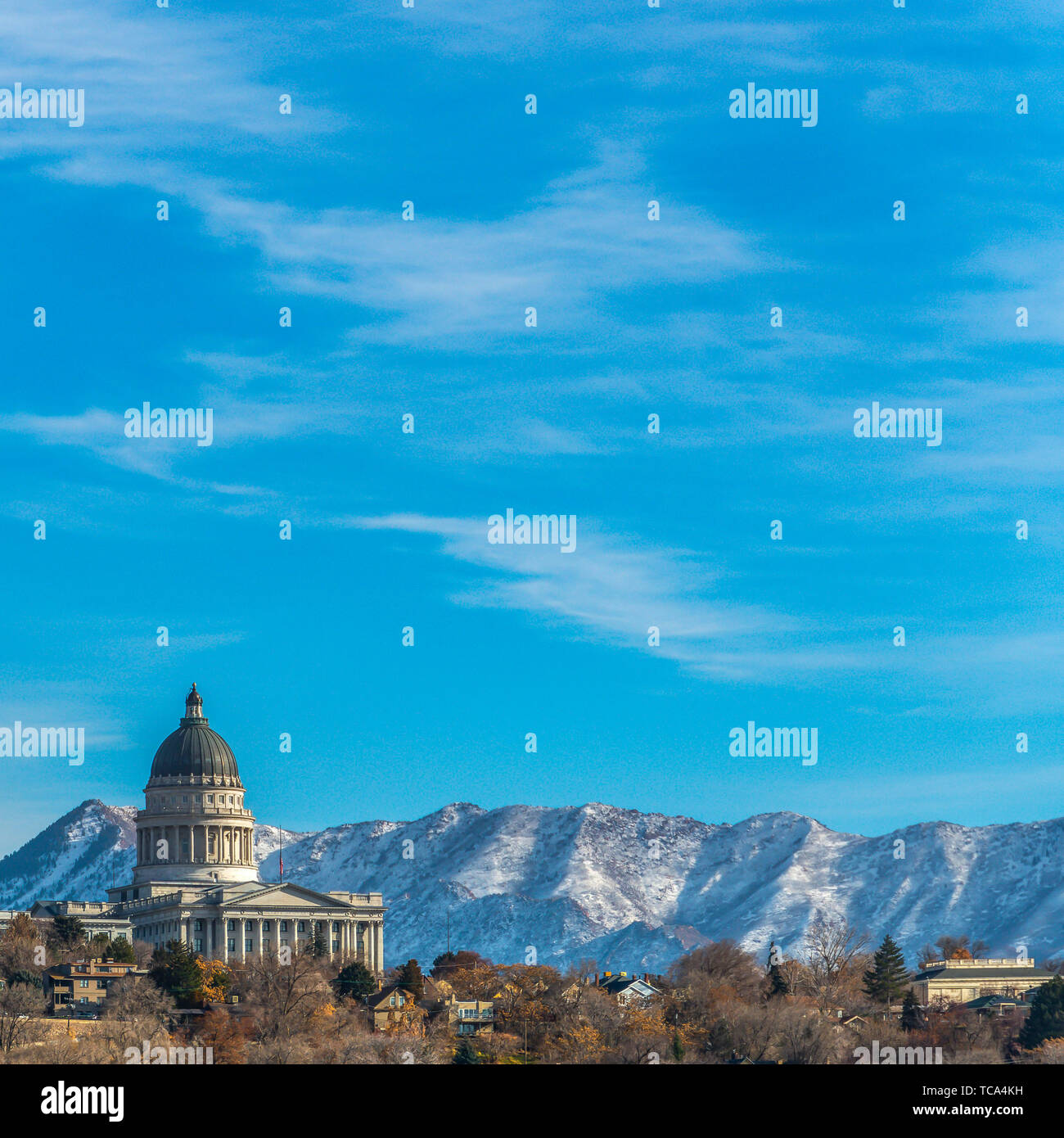 Square The majestic Utah State Capital Building towering over houses in ...