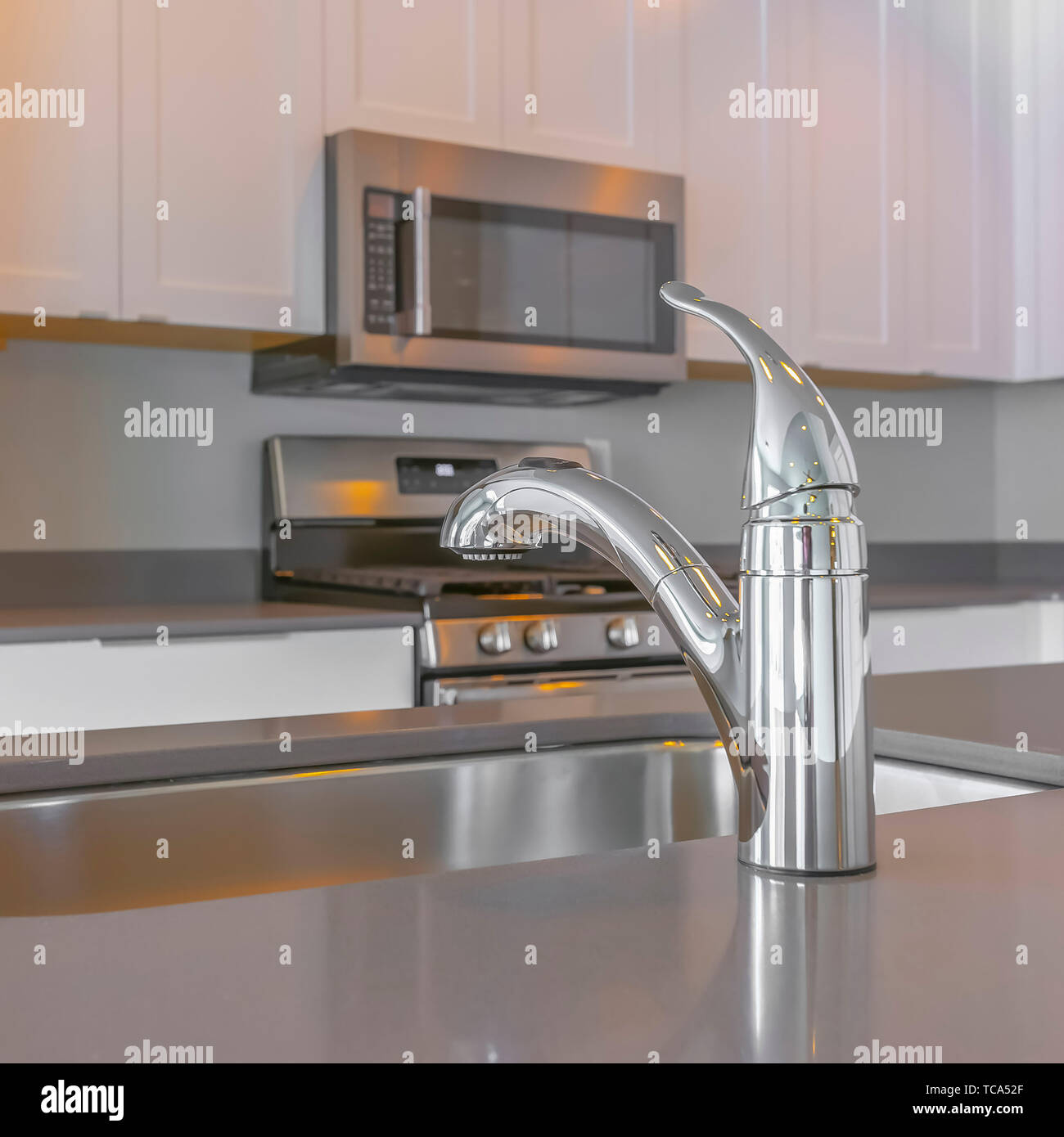 Frame Square Modern kitchen interior with faucet and sink on the glossy ...