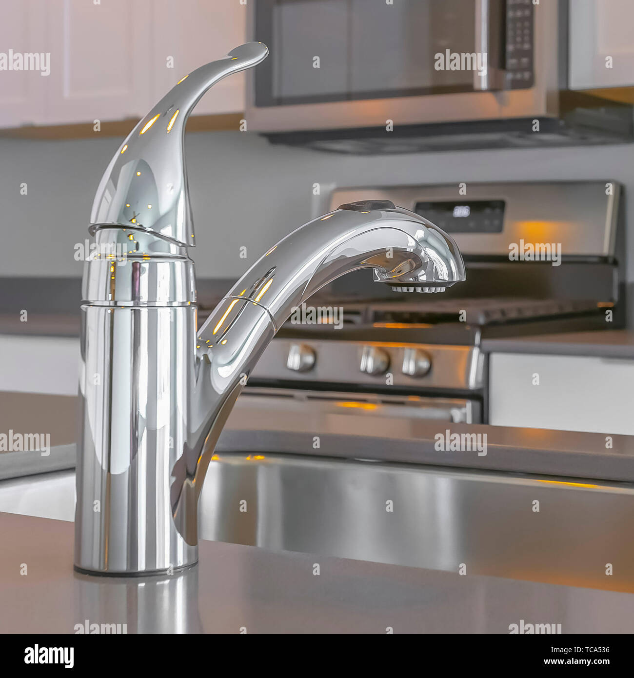 Square Modern kitchen interior with faucet and sink on the glossy ...