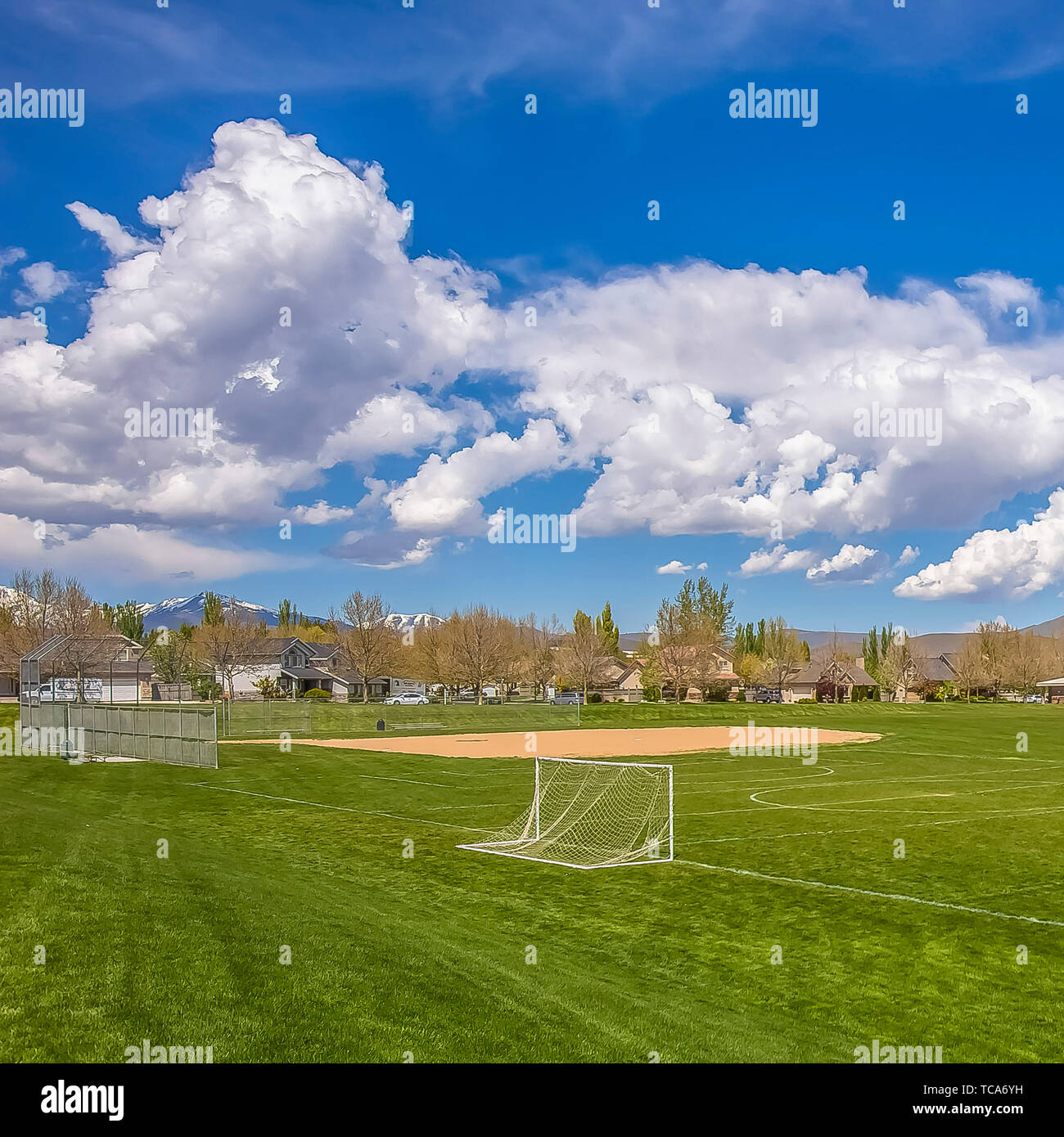 Square Soccer field and baseball field with view of mountain and cloudy ...
