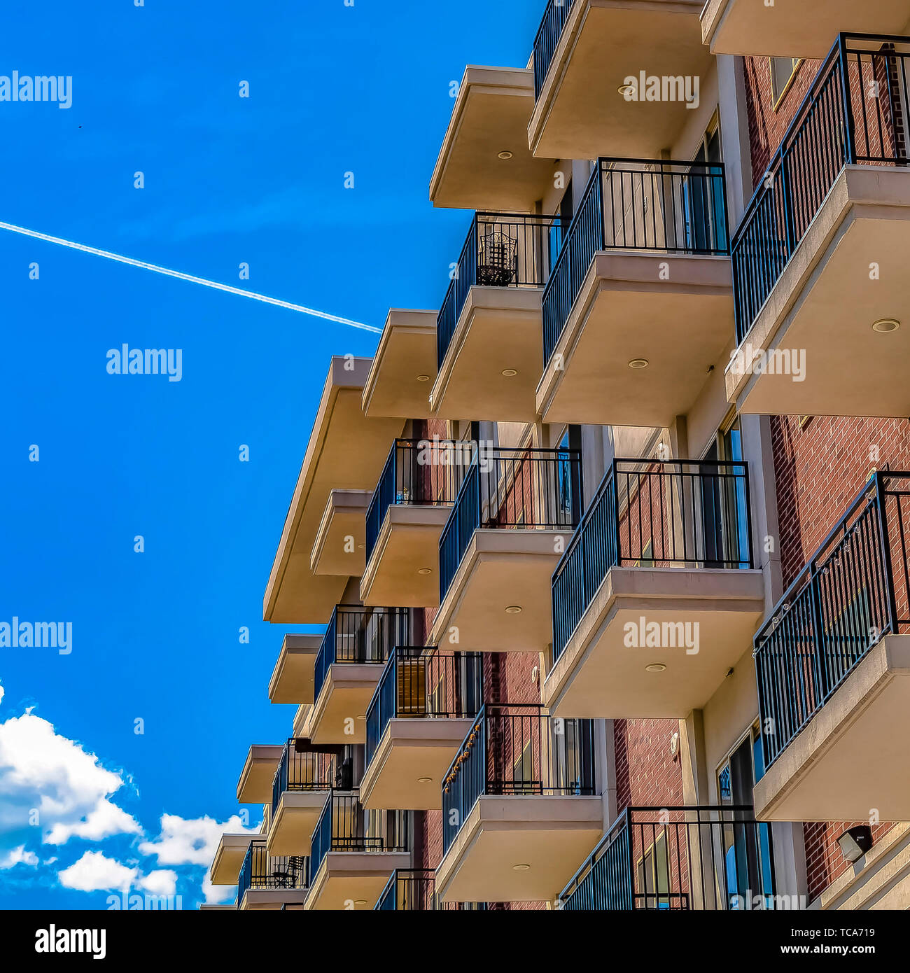 Square Small balconies of a residential building with exterior red ...
