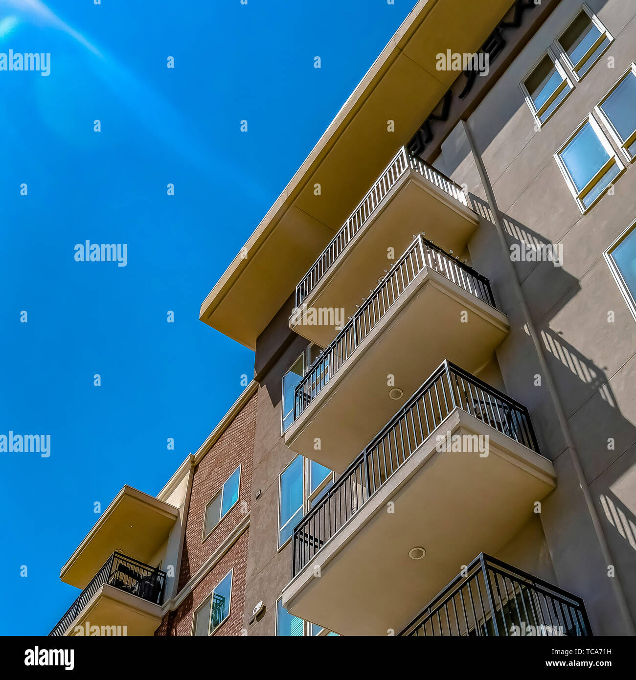 Frame Square View from below of a building with small balconies on a ...