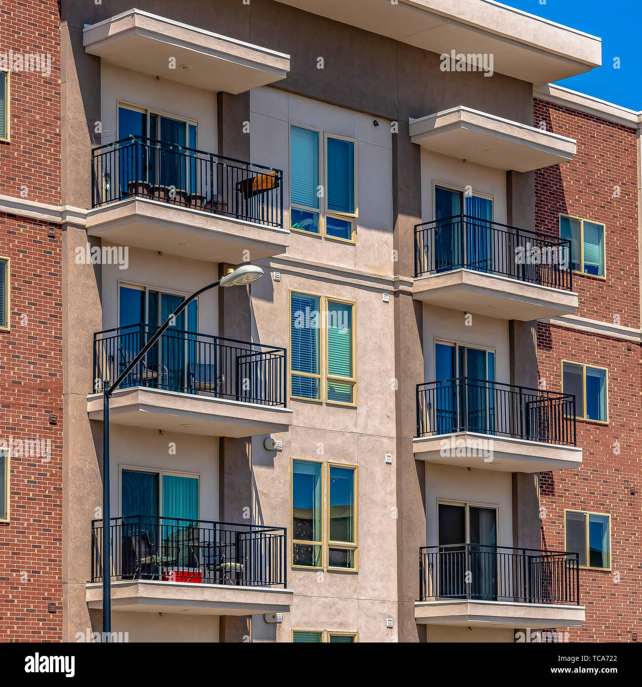 Square Residential building exterior with vivid blue sky background on ...