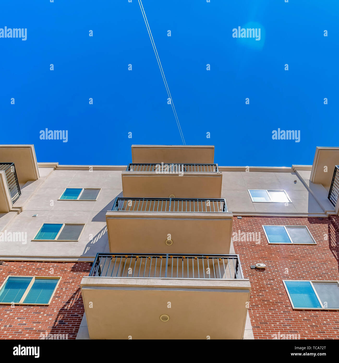 Frame Square Balconies of a building viewed from below against blue sky ...