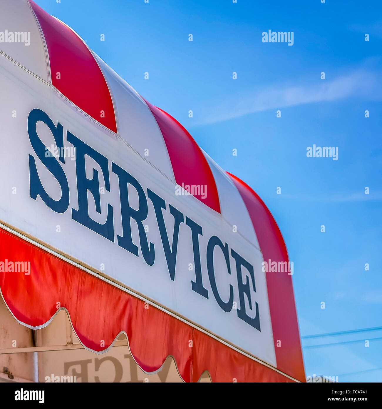 Square Car Service sign on the curved awning of a commercial brick ...
