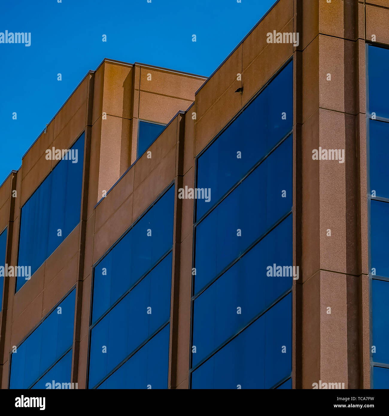 Square Close up of the exterior of a modern building with vivid blue ...