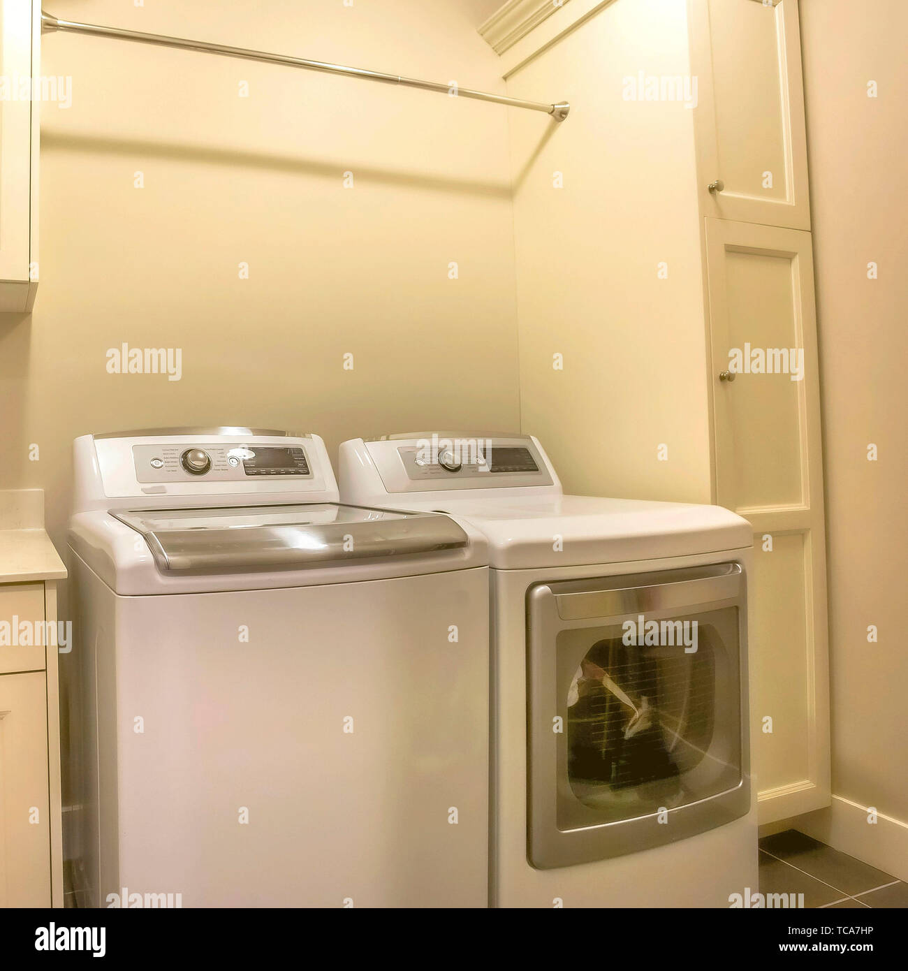 Square Washing machine and dryer inside the laundry room of a house ...