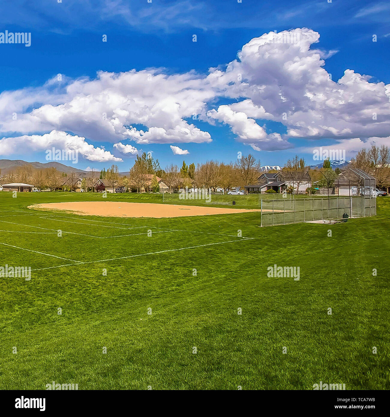 Square Panorama of a soccer field with houses and mountain in the ...