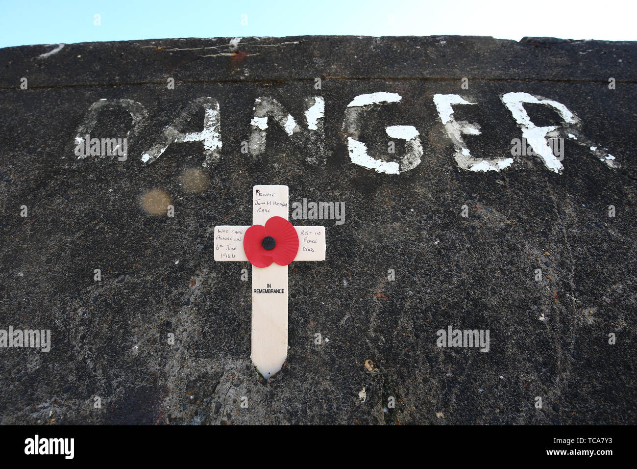 A memorial cross placed on the Mulberry harbour at Arromanches in ...