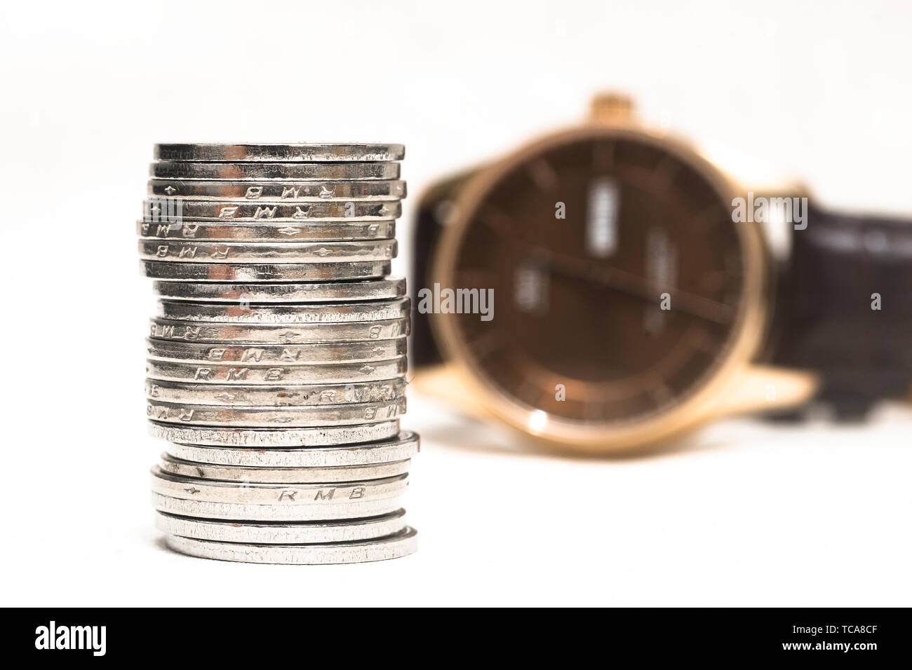 Coin with imaginary watch Stock Photo - Alamy