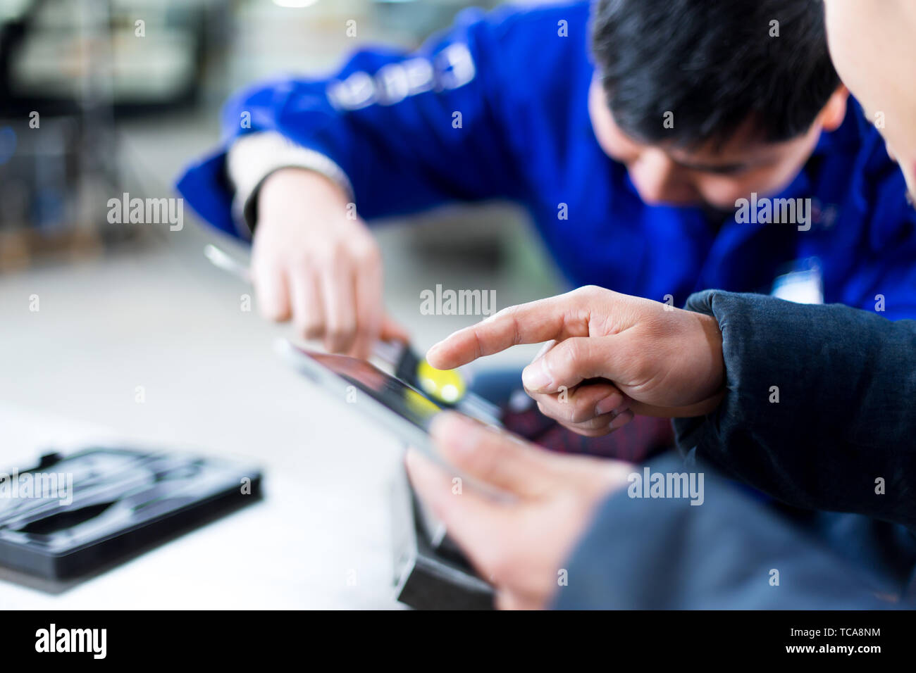 young technicians checking product in manufacturing factory Stock Photo ...