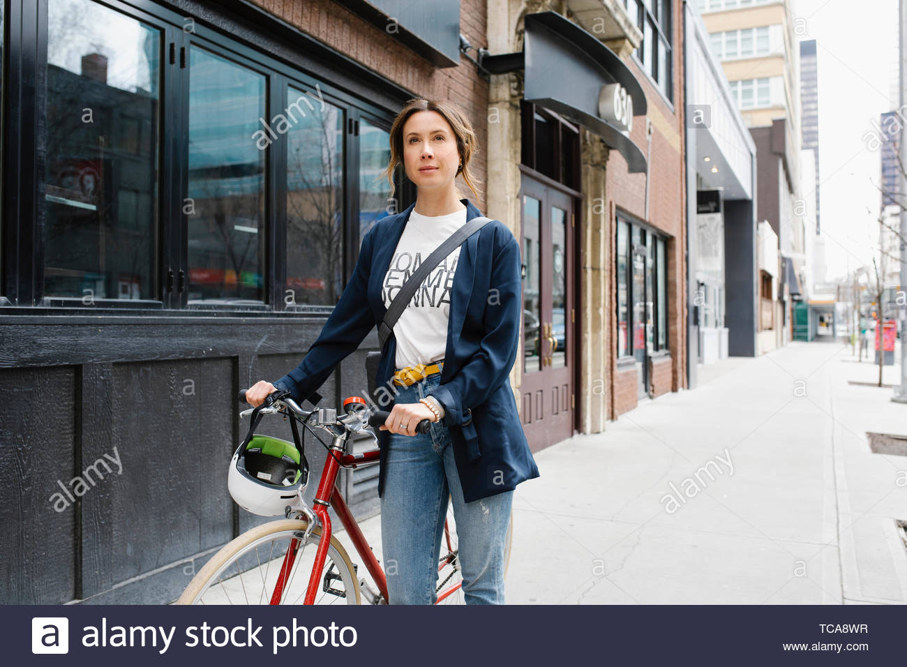 Woman walking her bicycle hi-res stock photography and images - Alamy