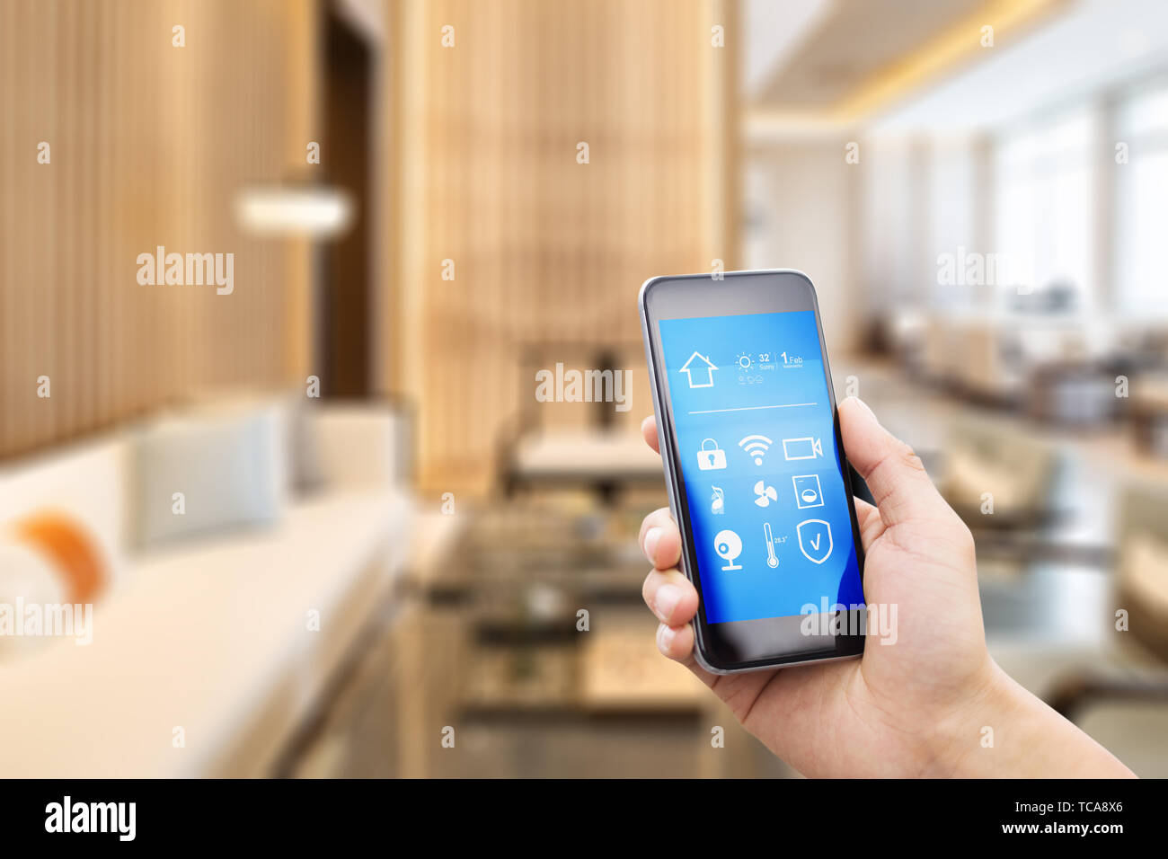 Mobile phone in smart home Stock Photo - Alamy