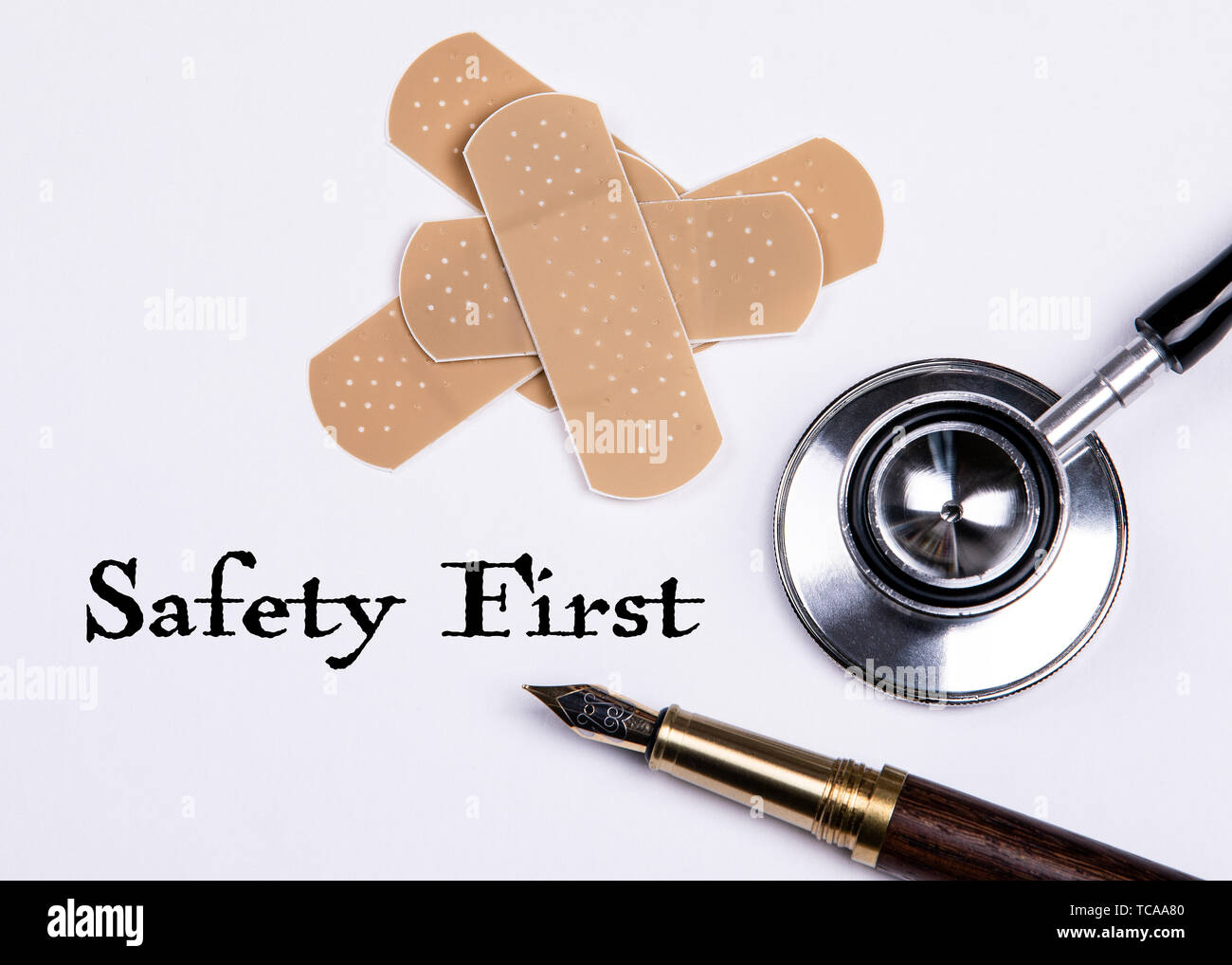 Safety First. Set of adhesive plasters and stethoscope on white ...