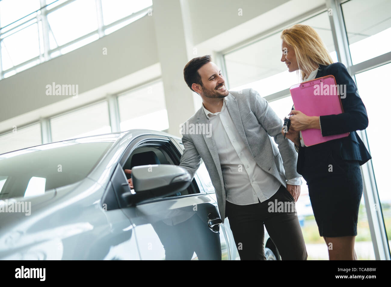 Portrait of happy customer buying new car Stock Photo - Alamy