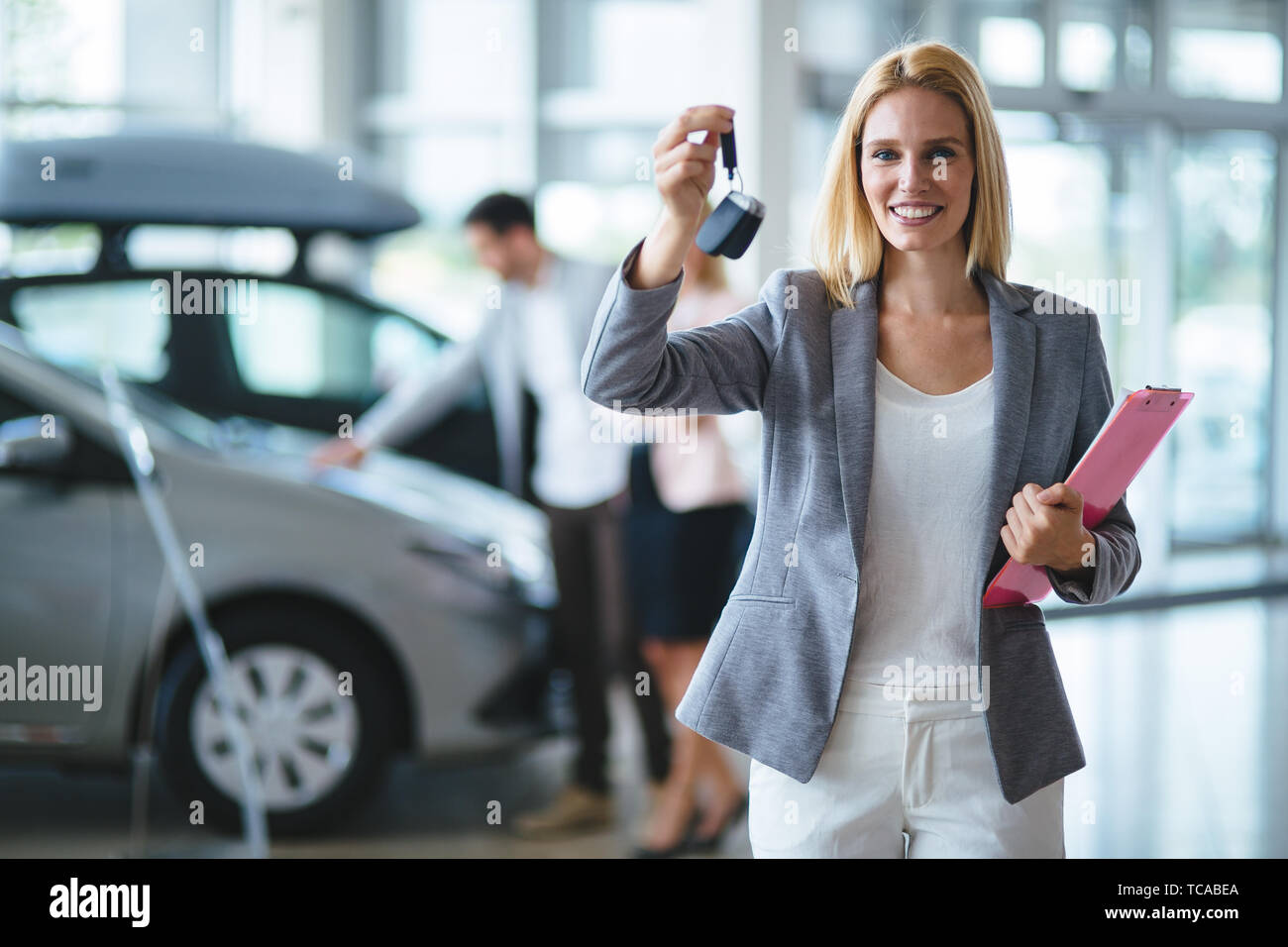 Professional salesperson selling cars at dealership to buyer Stock ...