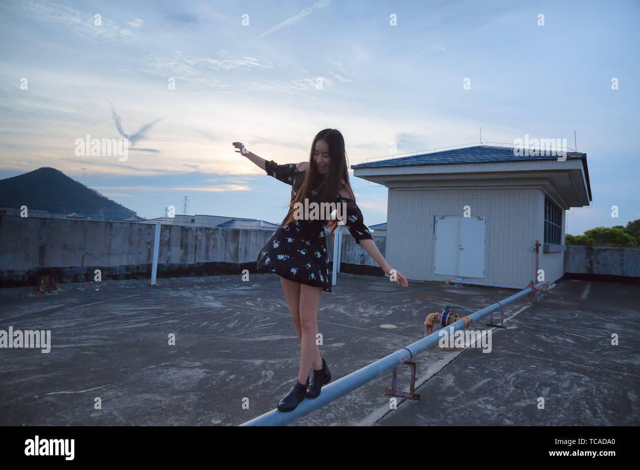 Cloud rooftop sky dusk girl girl Stock Photo - Alamy
