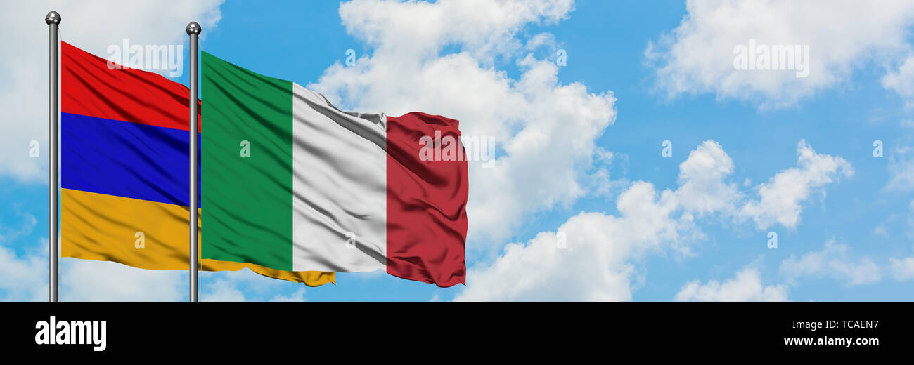 Armenia and Italy flag waving in the wind against white cloudy blue sky ...