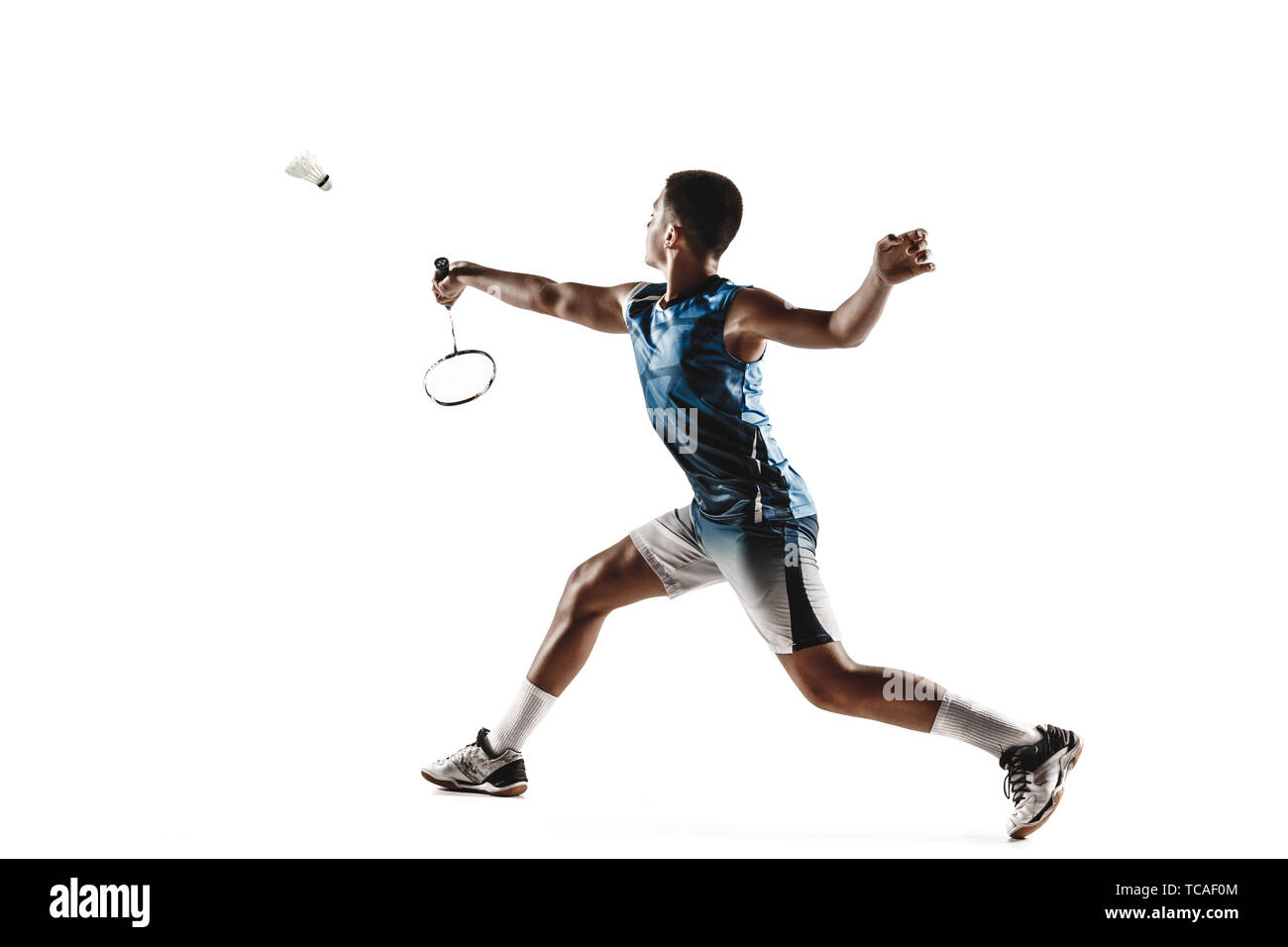 Little boy playing badminton isolated on white studio background. Young ...