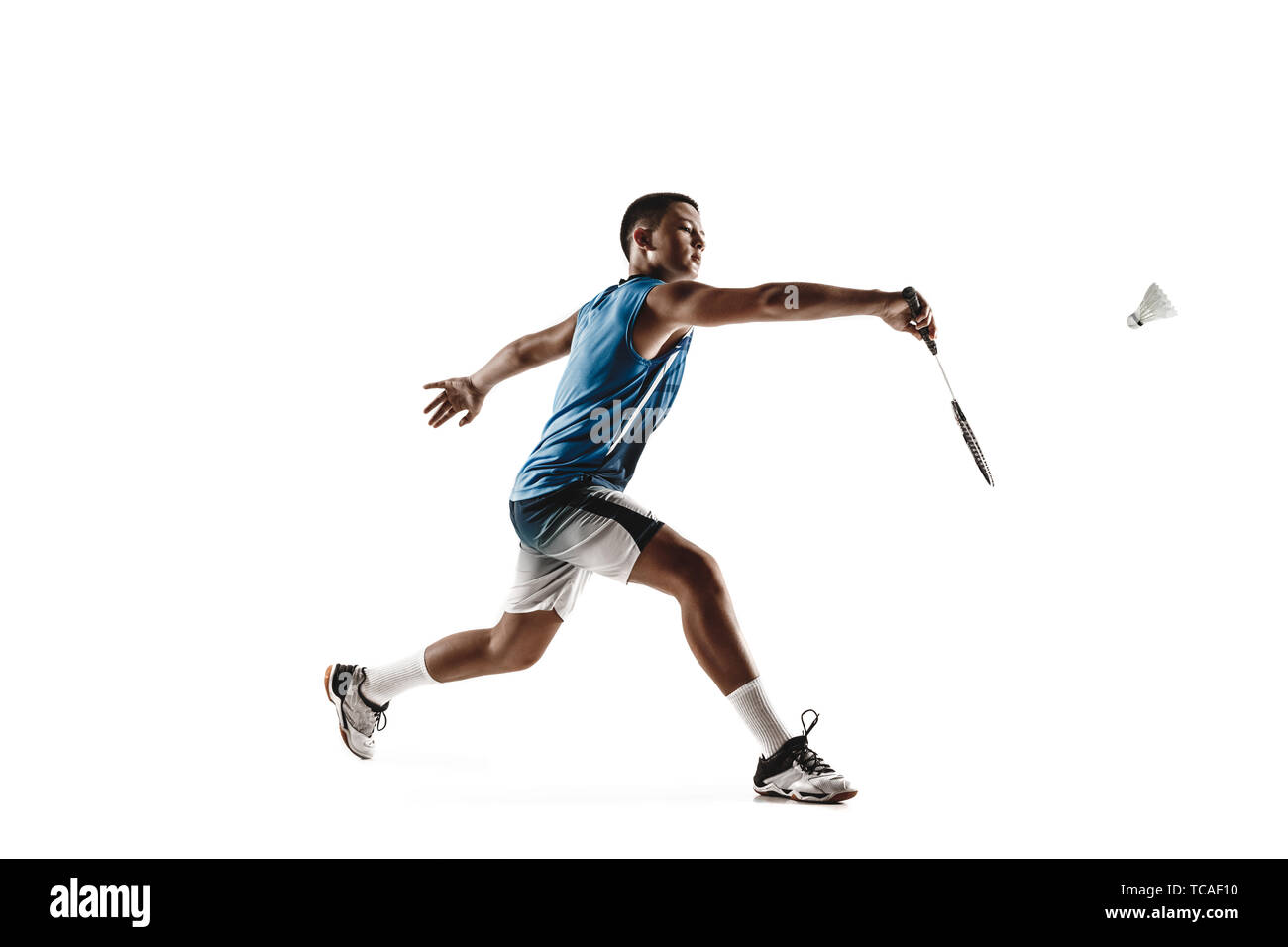 Little boy playing badminton isolated on white studio background. Young ...