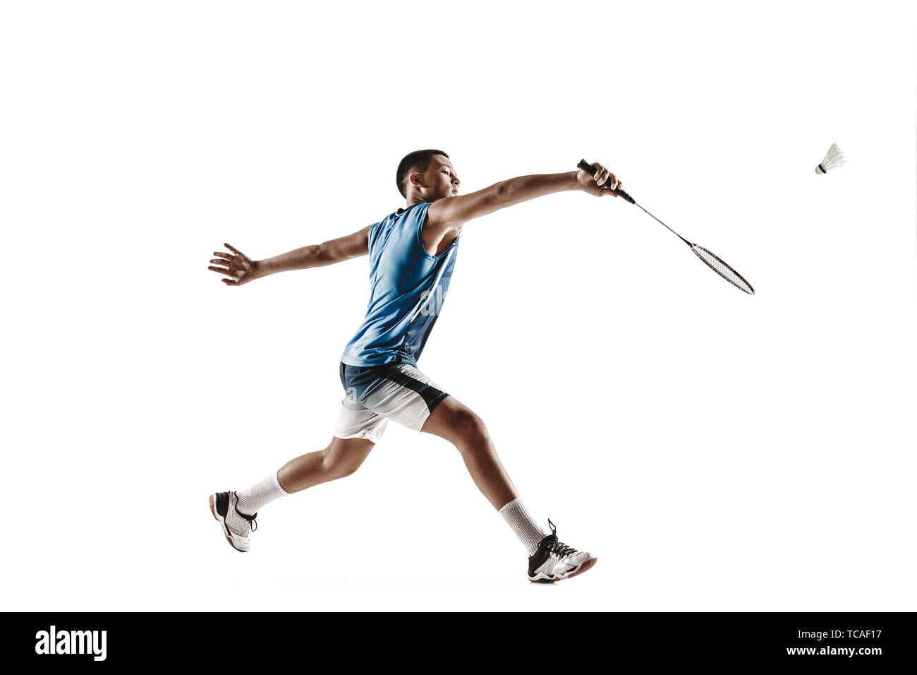 Little boy playing badminton isolated on white studio background. Young ...
