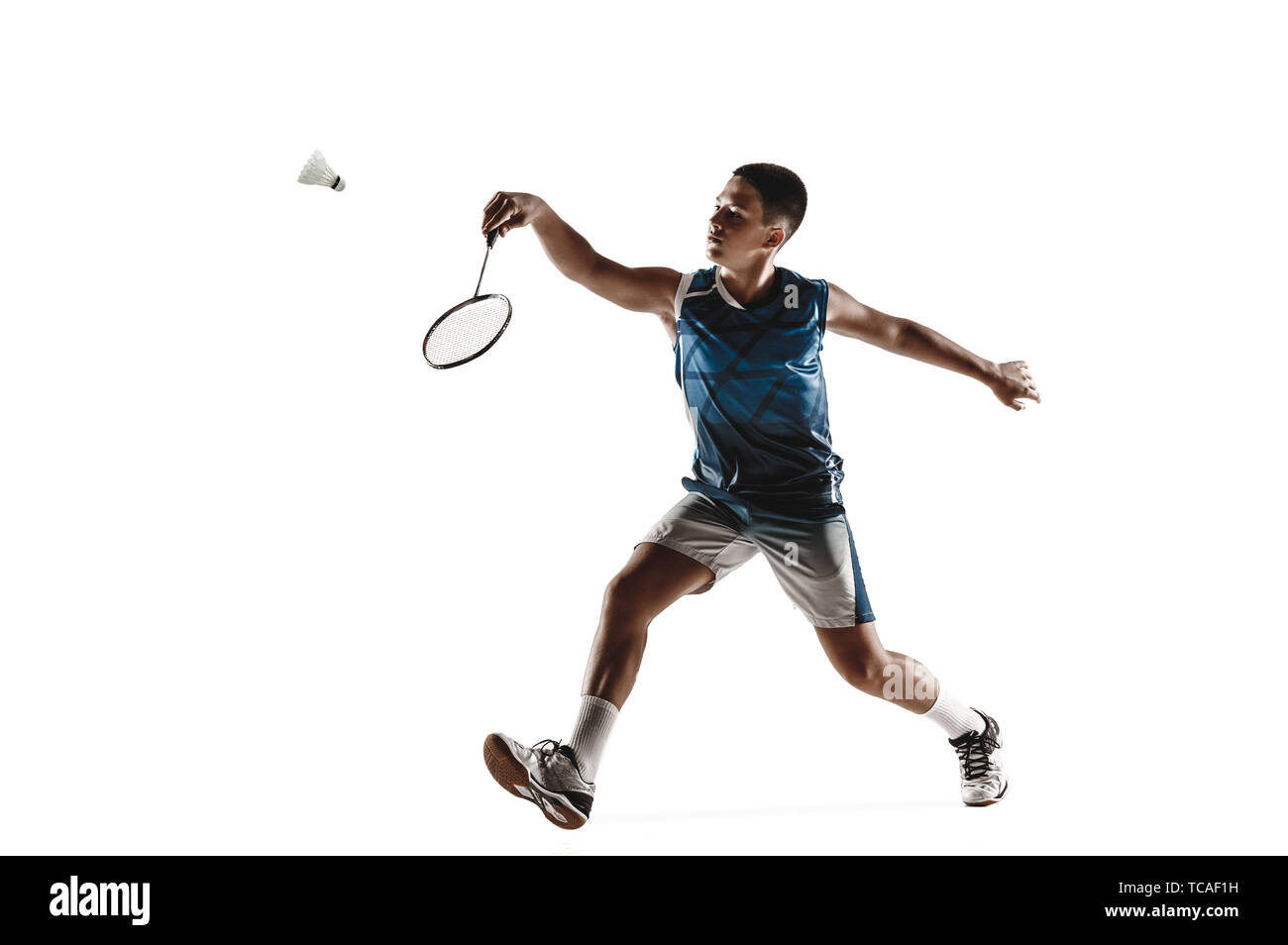 Little boy playing badminton isolated on white studio background. Young ...