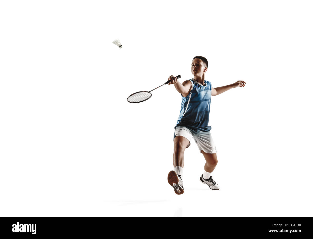 Little boy playing badminton isolated on white studio background. Young ...