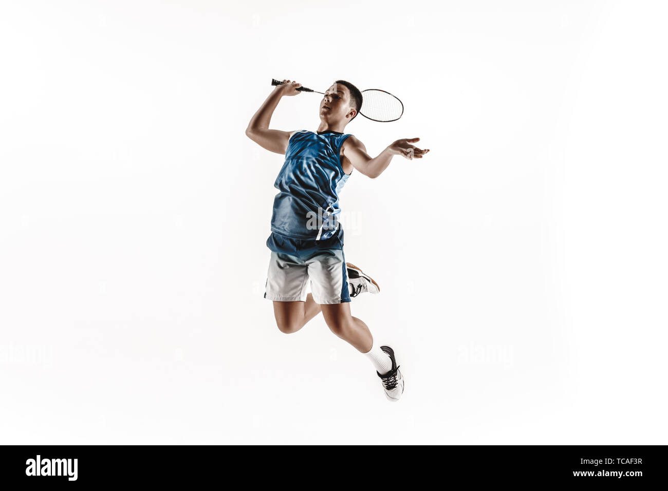 Little boy playing badminton isolated on white studio background. Young ...