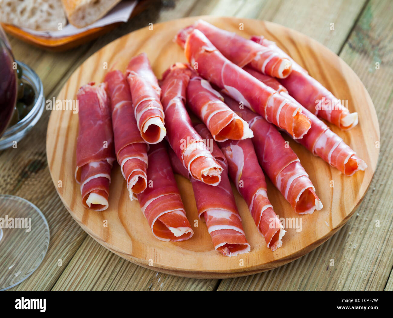 Traditional Spanish dish – jamon served in form of tubes on platter ...